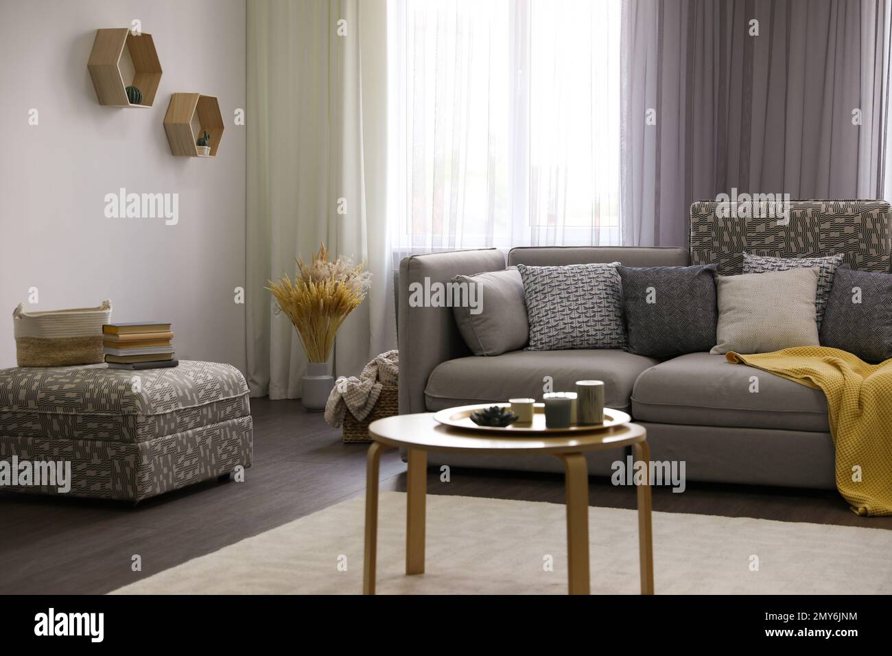 Elegant living room with comfortable sofa near window. Interior design ...