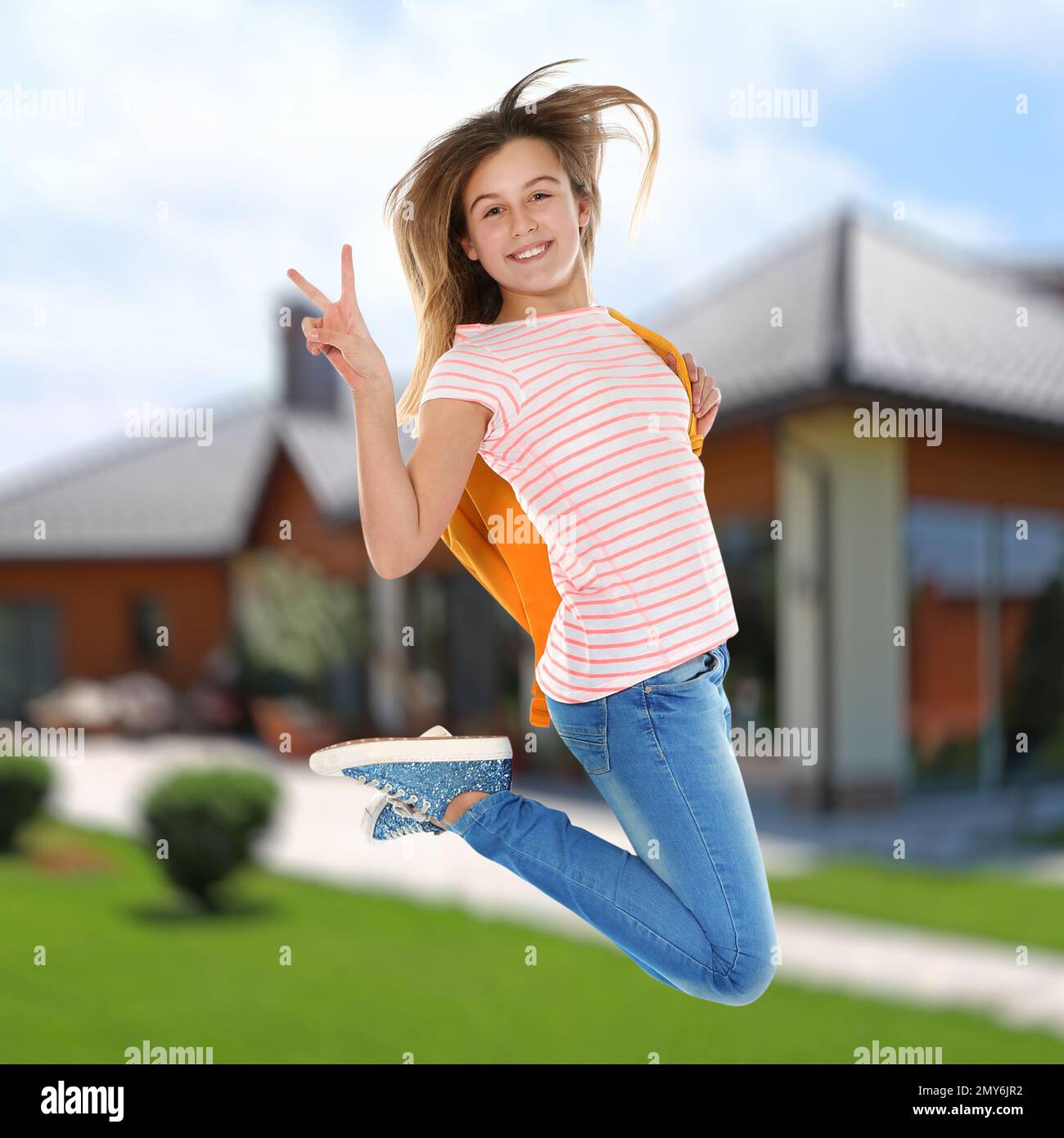 Happy teenage girl jumping near house. School holidays Stock Photo - Alamy
