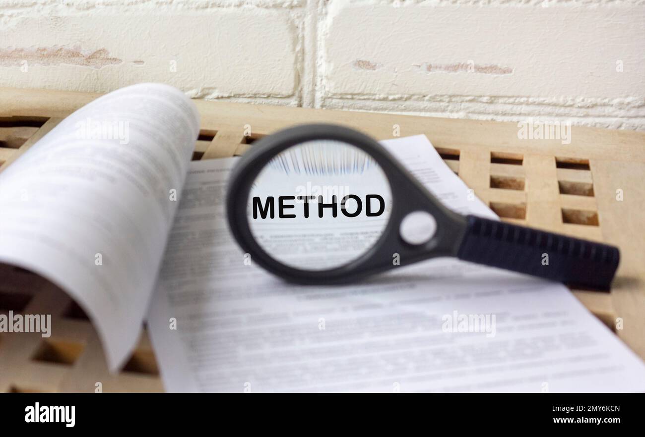 Magnifier with text Method lies on financial documents. financial ...