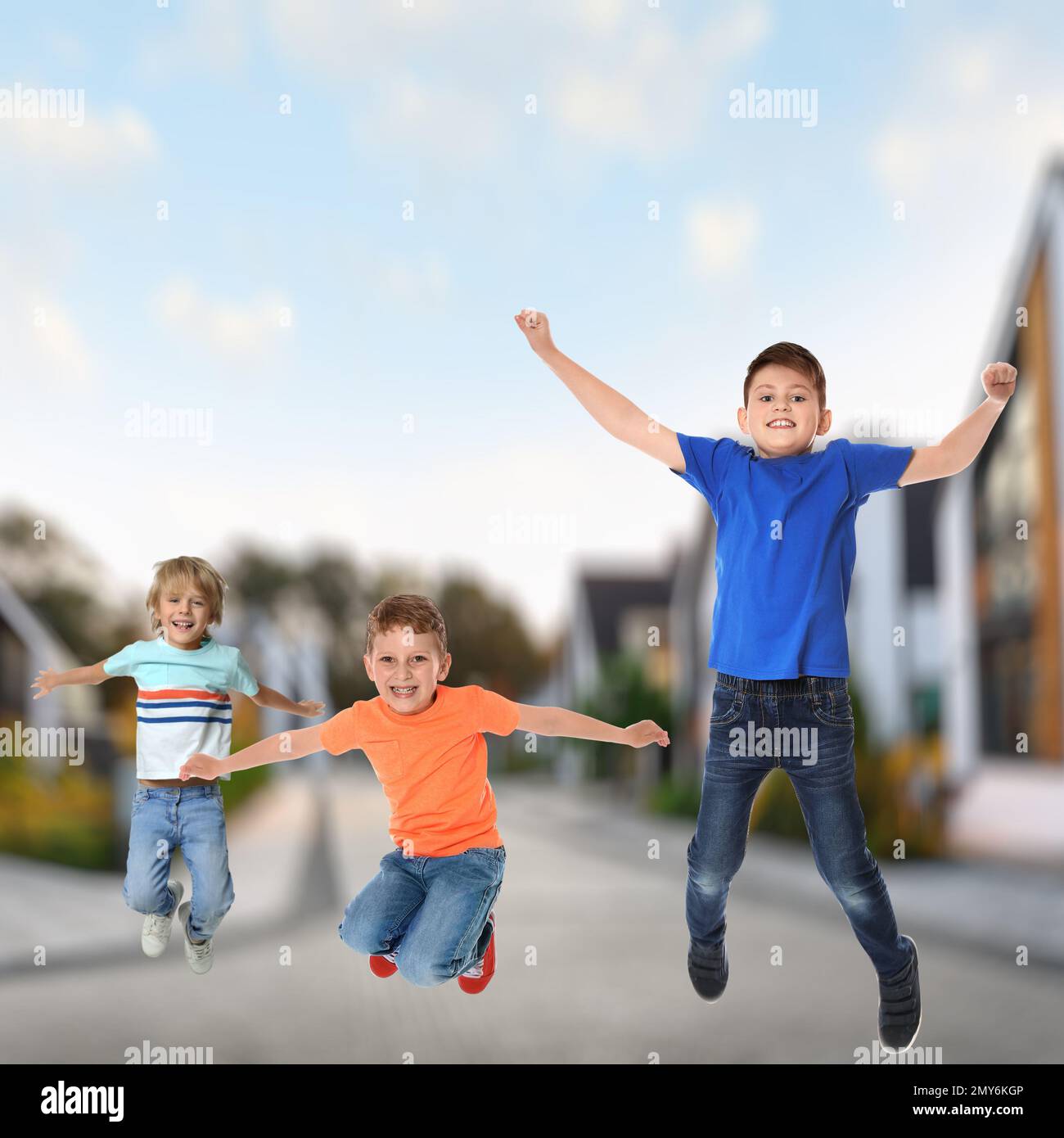 Happy boys jumping on street. School holidays Stock Photo - Alamy