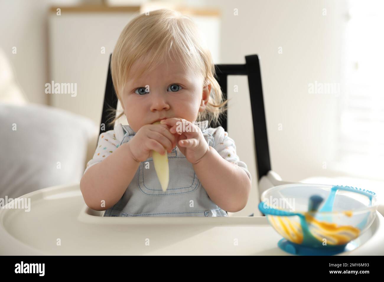 Cute little baby eating vegetable at home. Healthy food Stock Photo - Alamy