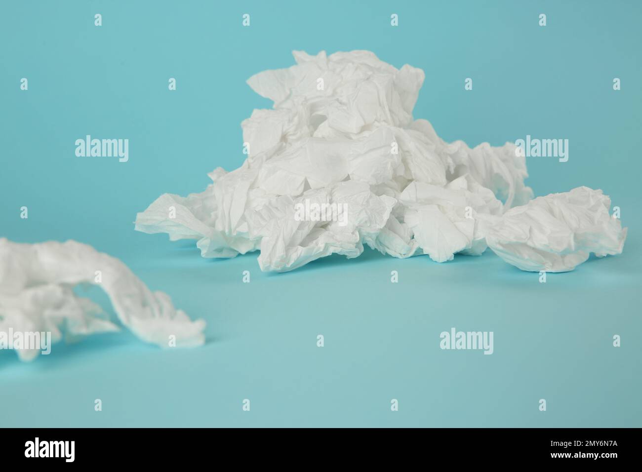 Used paper tissues on light blue background, closeup Stock Photo - Alamy