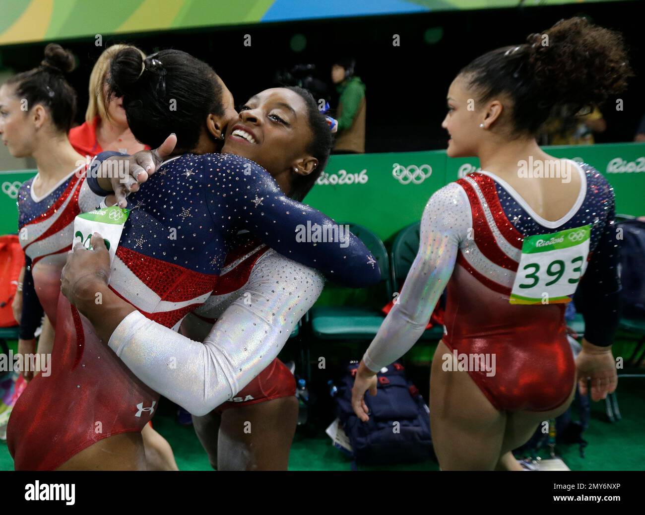 United States' Simone Biles, facing camera, hugs teammate Gabrielle ...