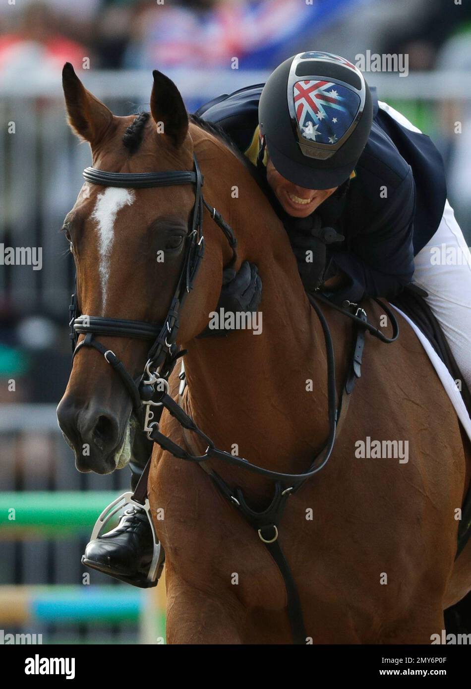 Sam Griffiths, of Australia, hugs horse Paulank Brockagh, after ...