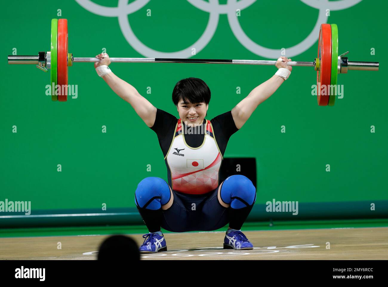 Namika Matsumoto, of Japan, competes in the women's 63kg weightlifting ...