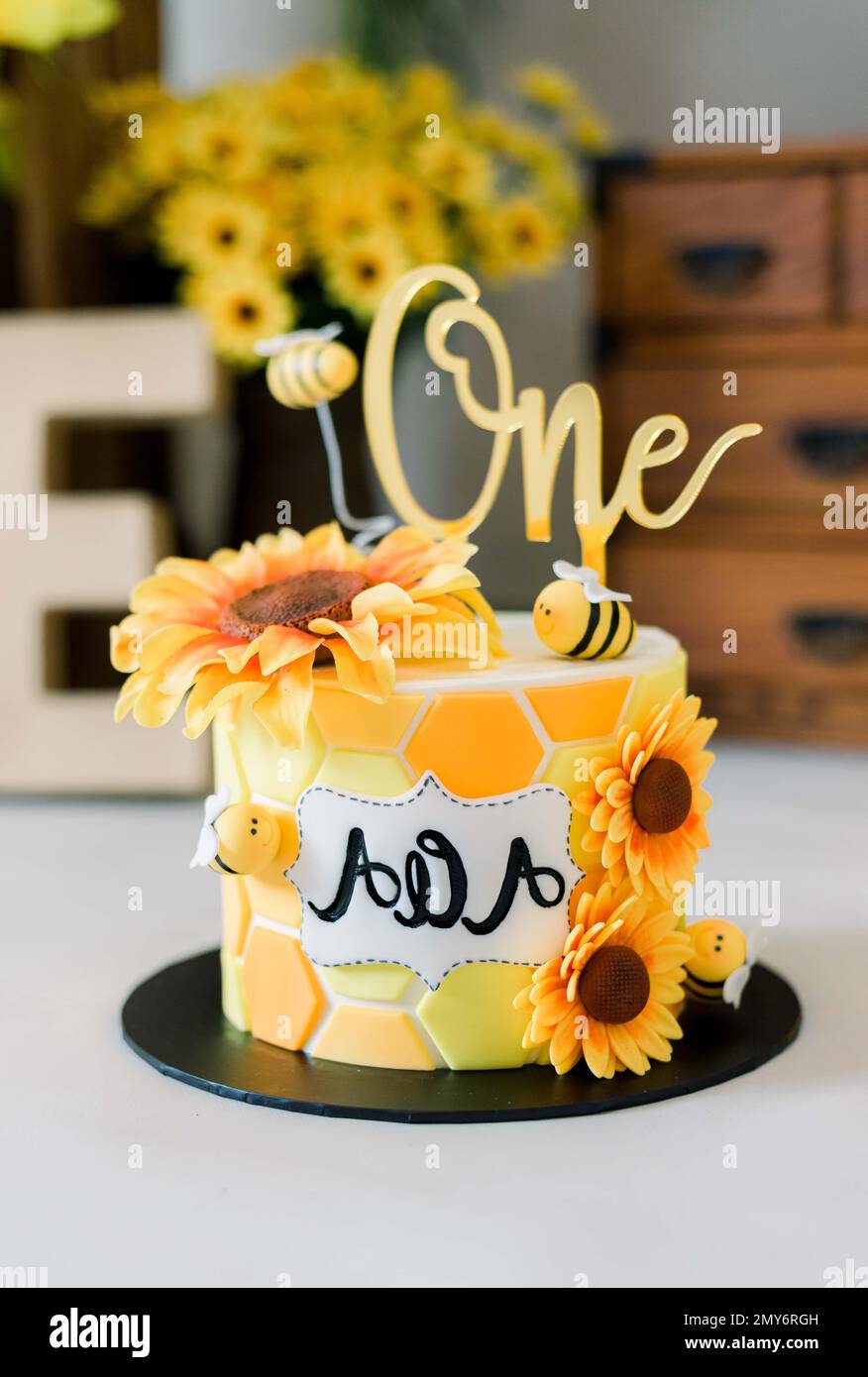 The bee theme first birthday cake with sunflowers Stock Photo - Alamy