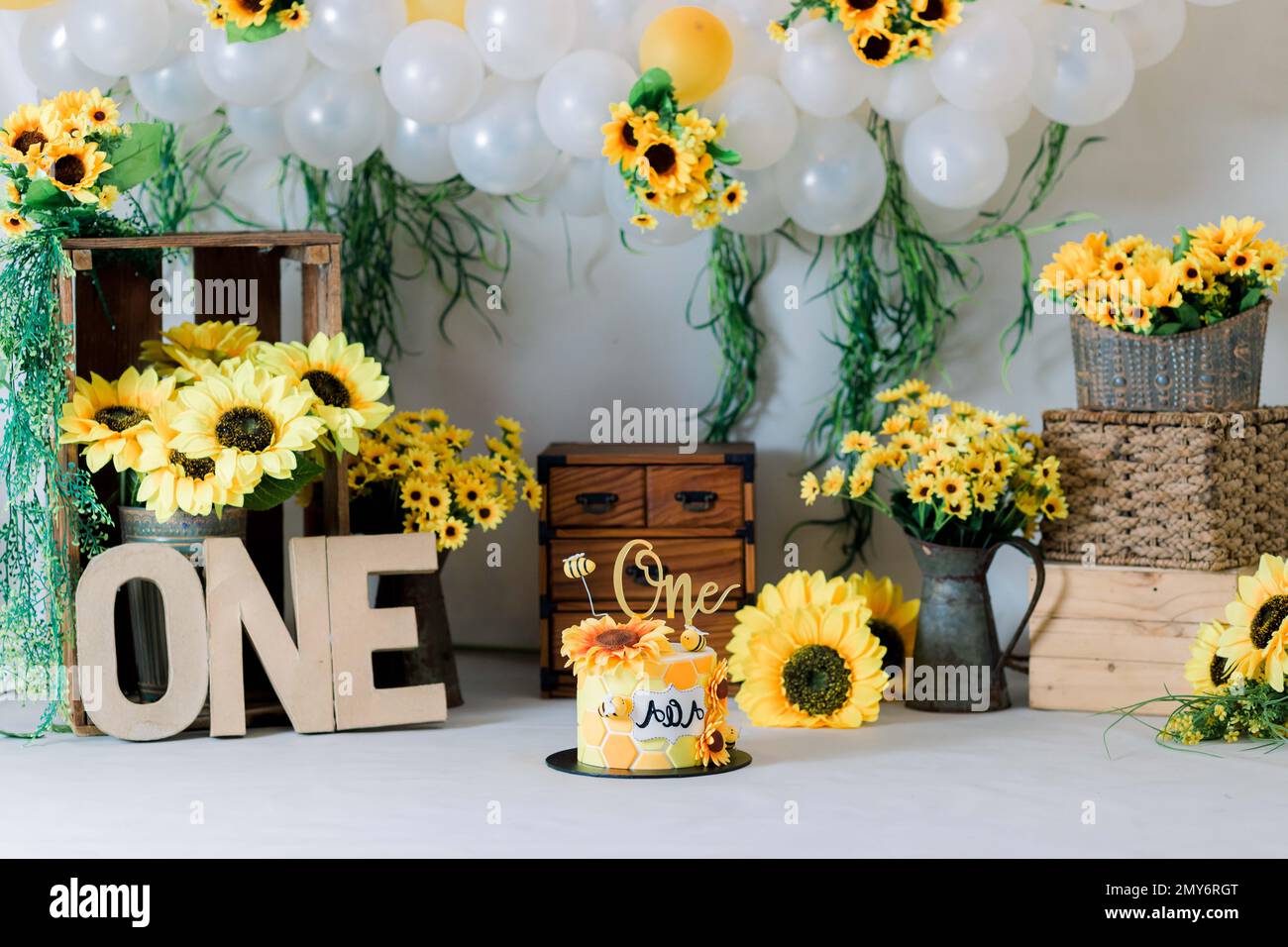 The bee theme first birthday cake with sunflowers and balloons Stock ...
