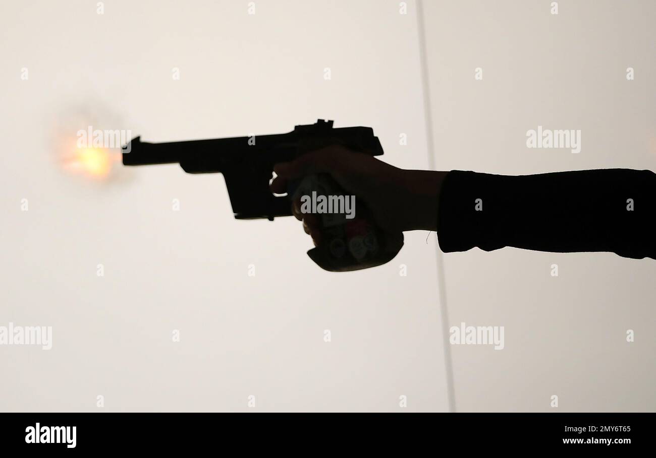 An athlete competes during the women's 25 meter pistol qualification ...