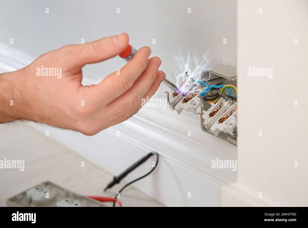 Electrician receiving electric shock while working, closeup Stock Photo ...