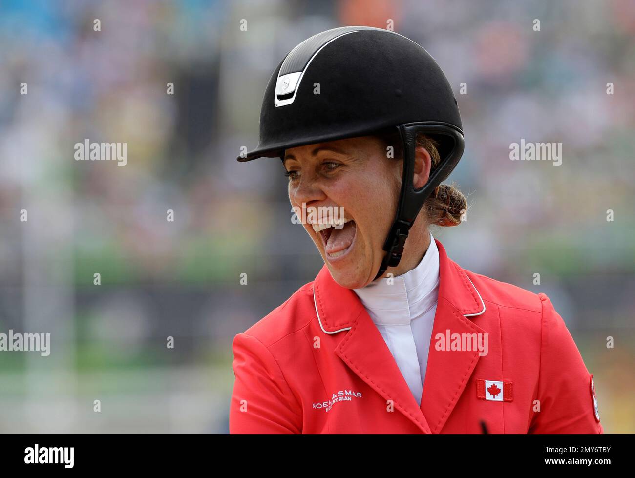 Rebecca Howard, of Canada, reacts after competing in equestrian jumping ...