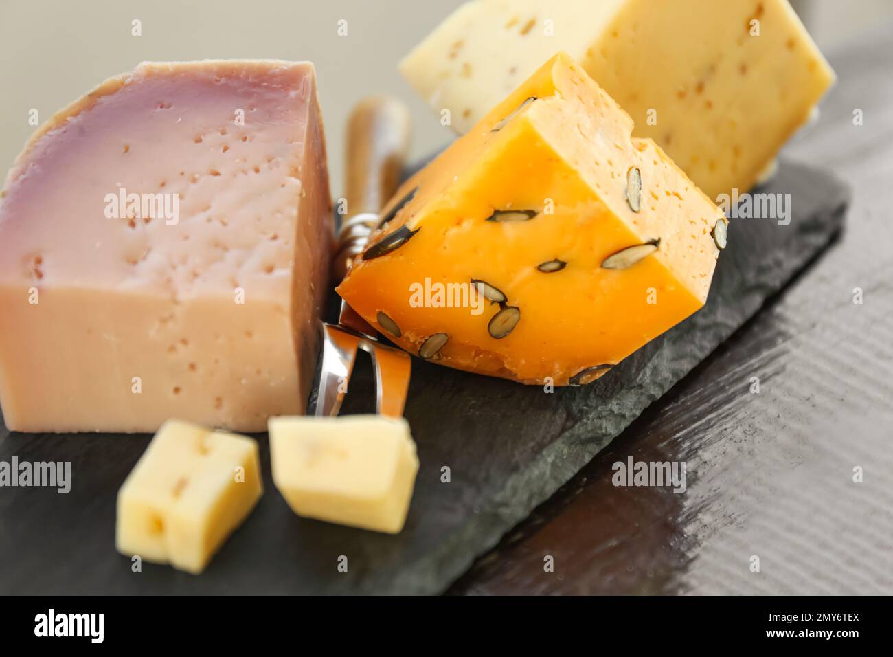 Different types of delicious cheeses on wooden table, closeup Stock ...