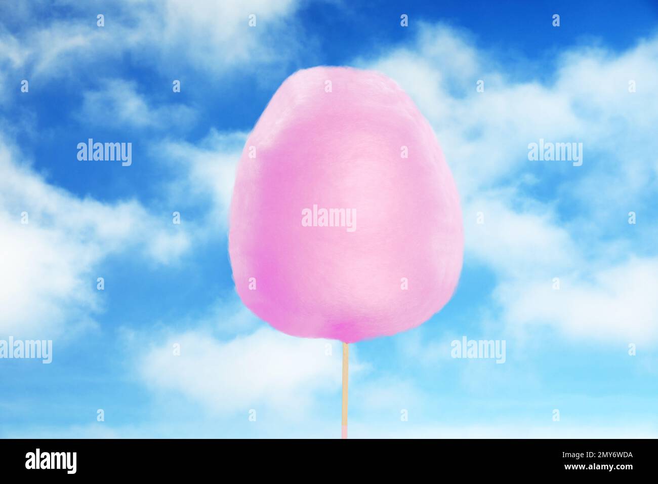 Pink cotton candy against blue sky with clouds Stock Photo - Alamy