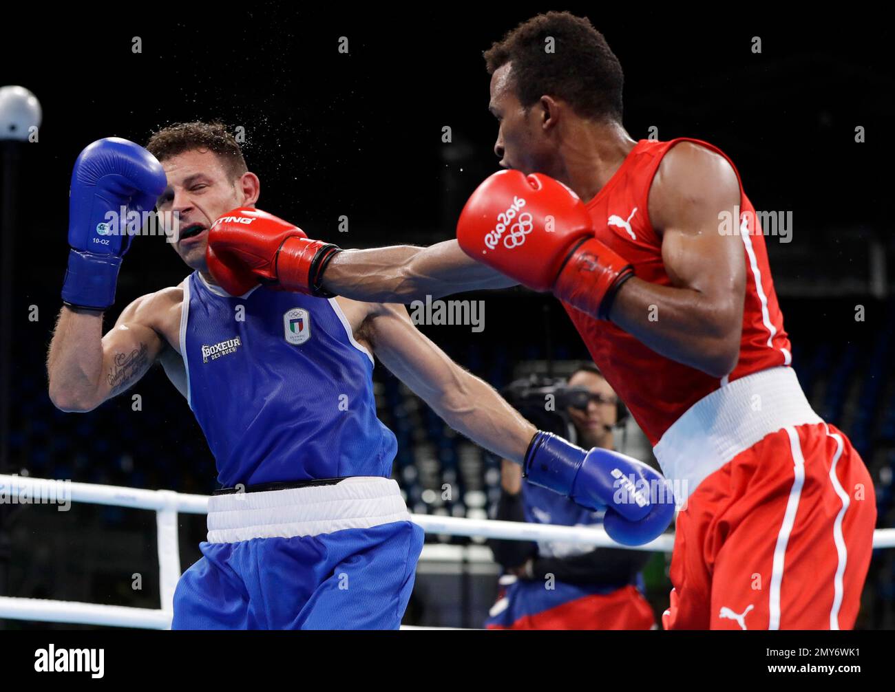 Cuba's Lazaro Alvarez, right, fights Italy's Carmine Tommasone during a ...