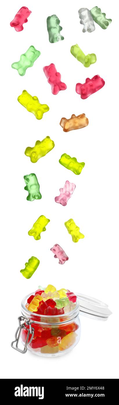 Delicious jelly candies falling into glass jar on white background ...