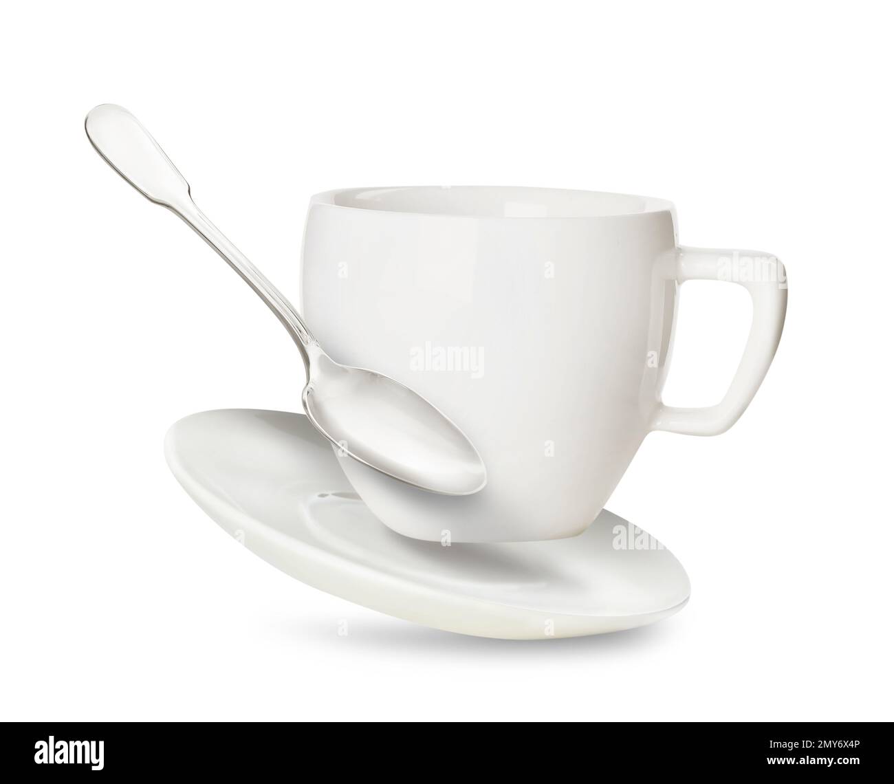 Clean cup with saucer and teaspoon in flight on white background Stock ...