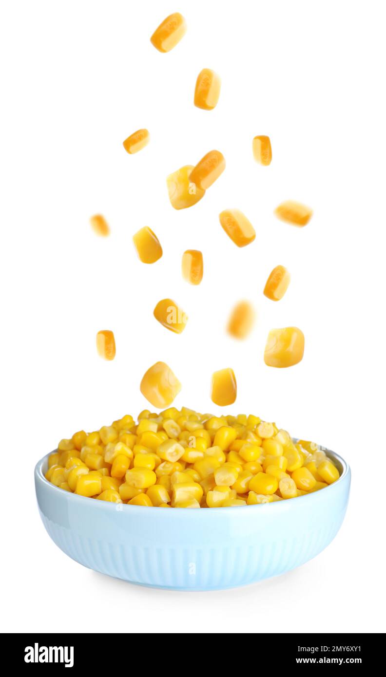 Sweet corn kernels falling into bowl on white background Stock Photo ...