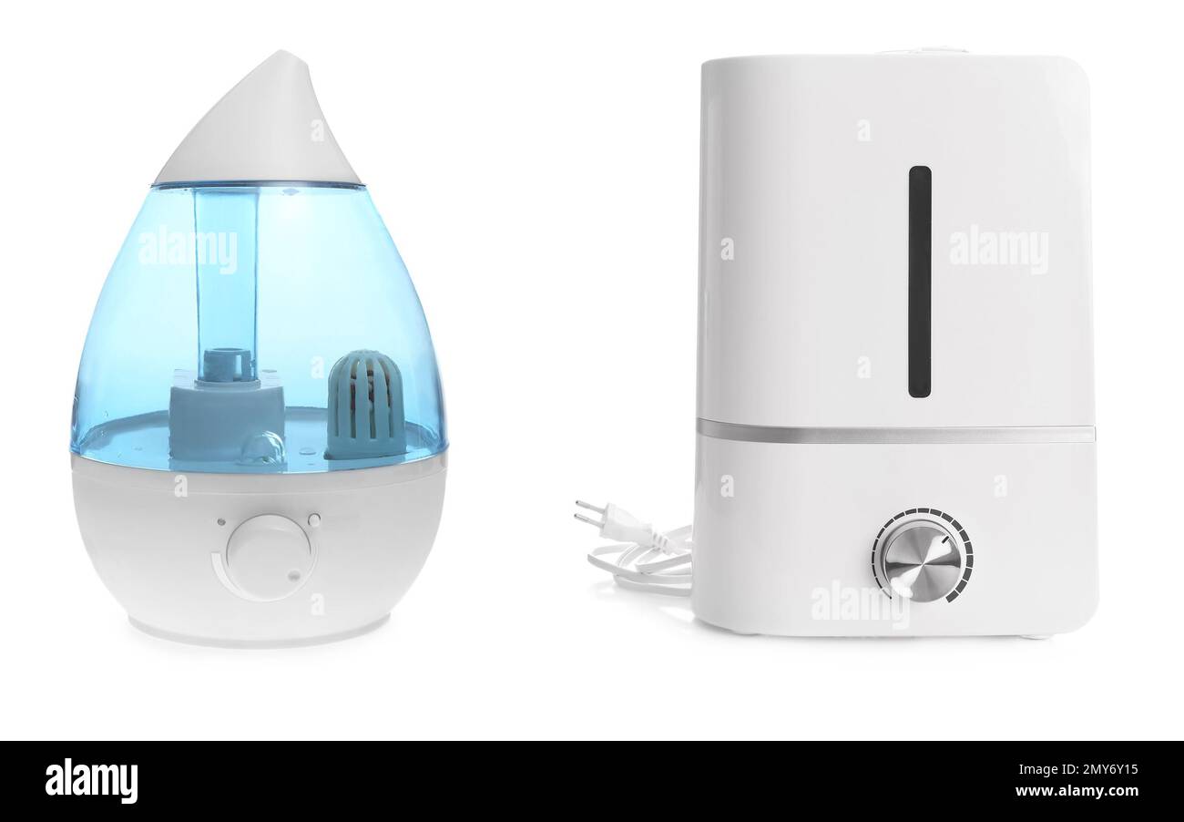 Two modern air humidifiers on white background Stock Photo - Alamy