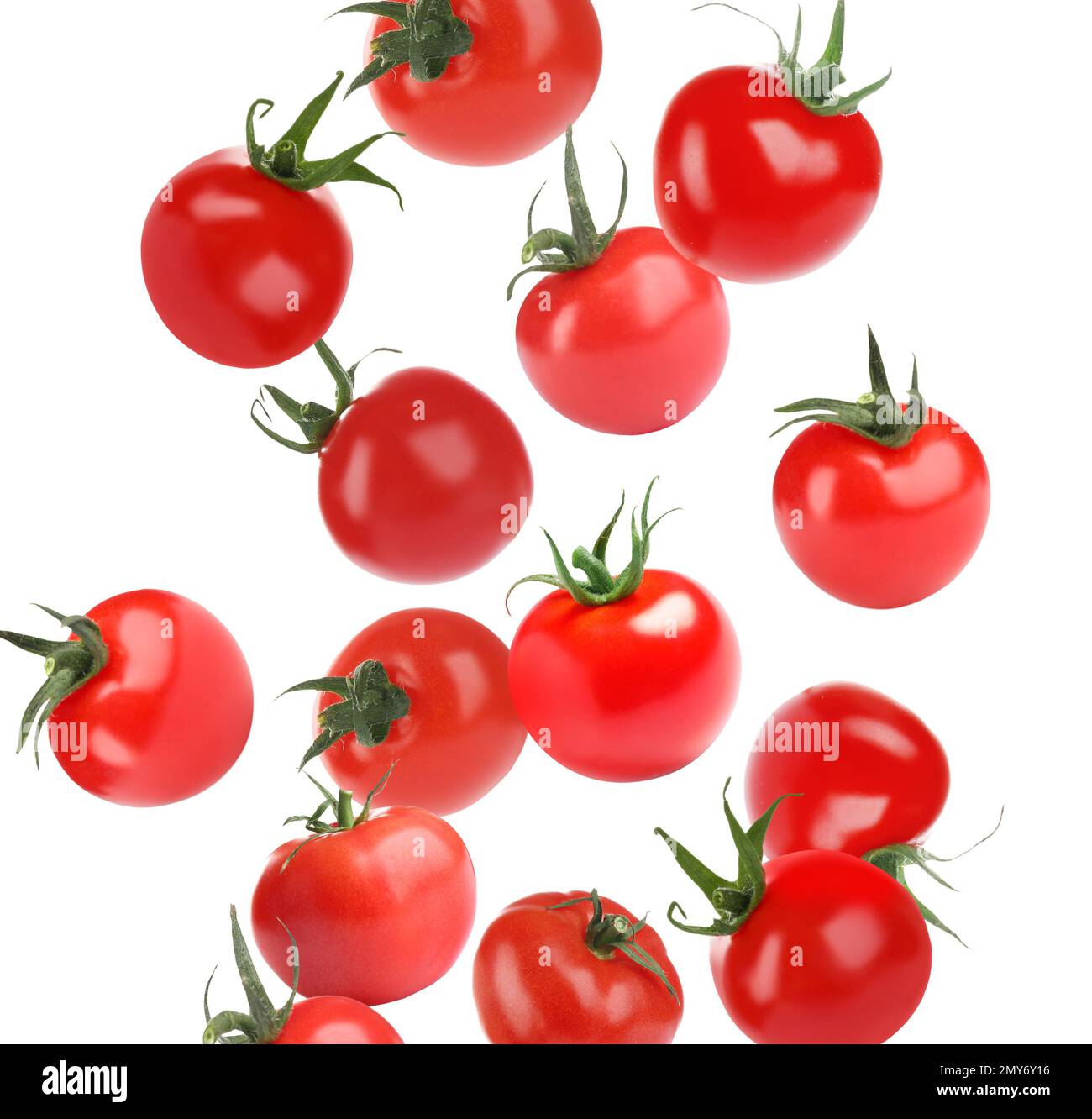 Many whole tomatoes falling on white background Stock Photo - Alamy