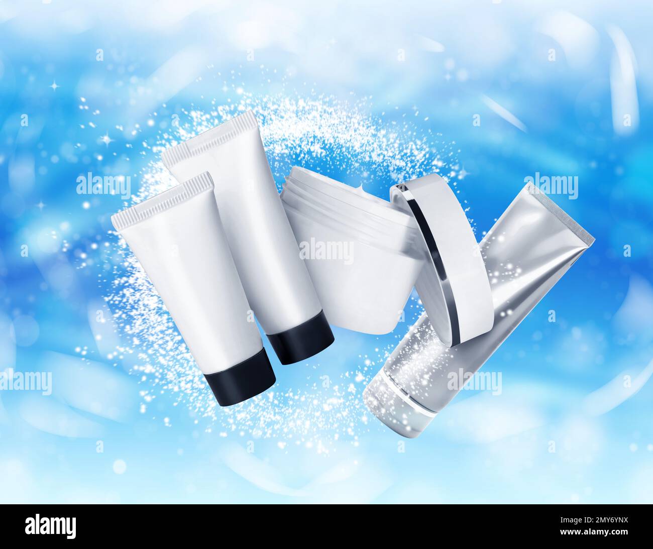 Different cosmetic products on light blue background with bokeh effect. Winter skin care Stock ...