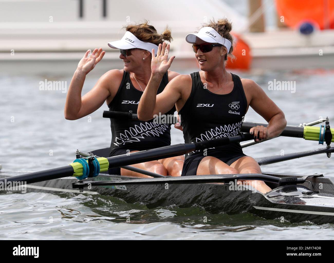 Genevieve Behrent and Rebecca Scown, of New Zealand, wave to the crowd ...