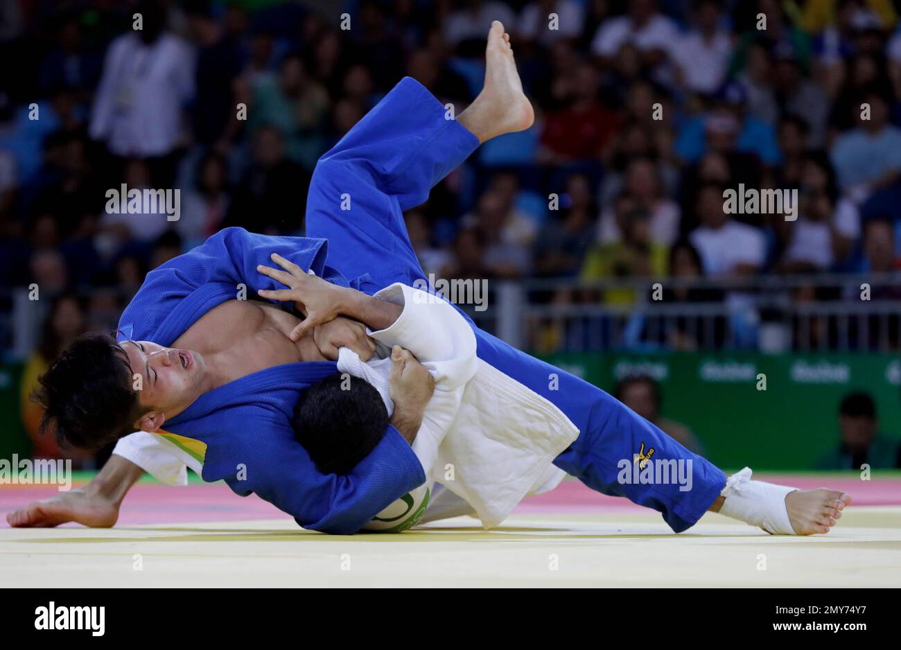 Japan's Shohei Ono, blue, and Georgia's Lasha Shavdatuashvili compete during the men's 73-kg ...