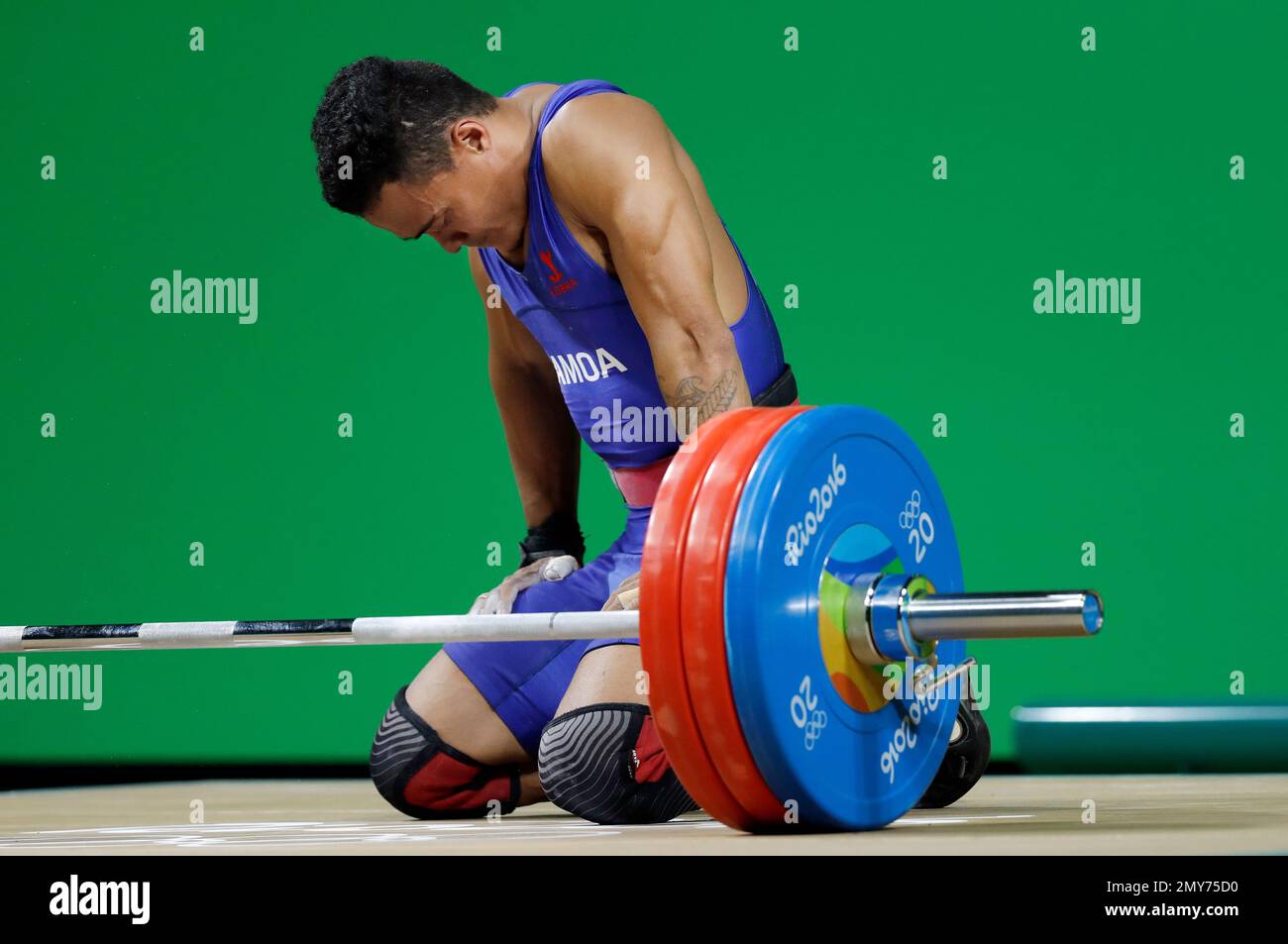 Vaipava Nevo Ioane, of Samoa, kneels on the floor after an unsuccessful ...