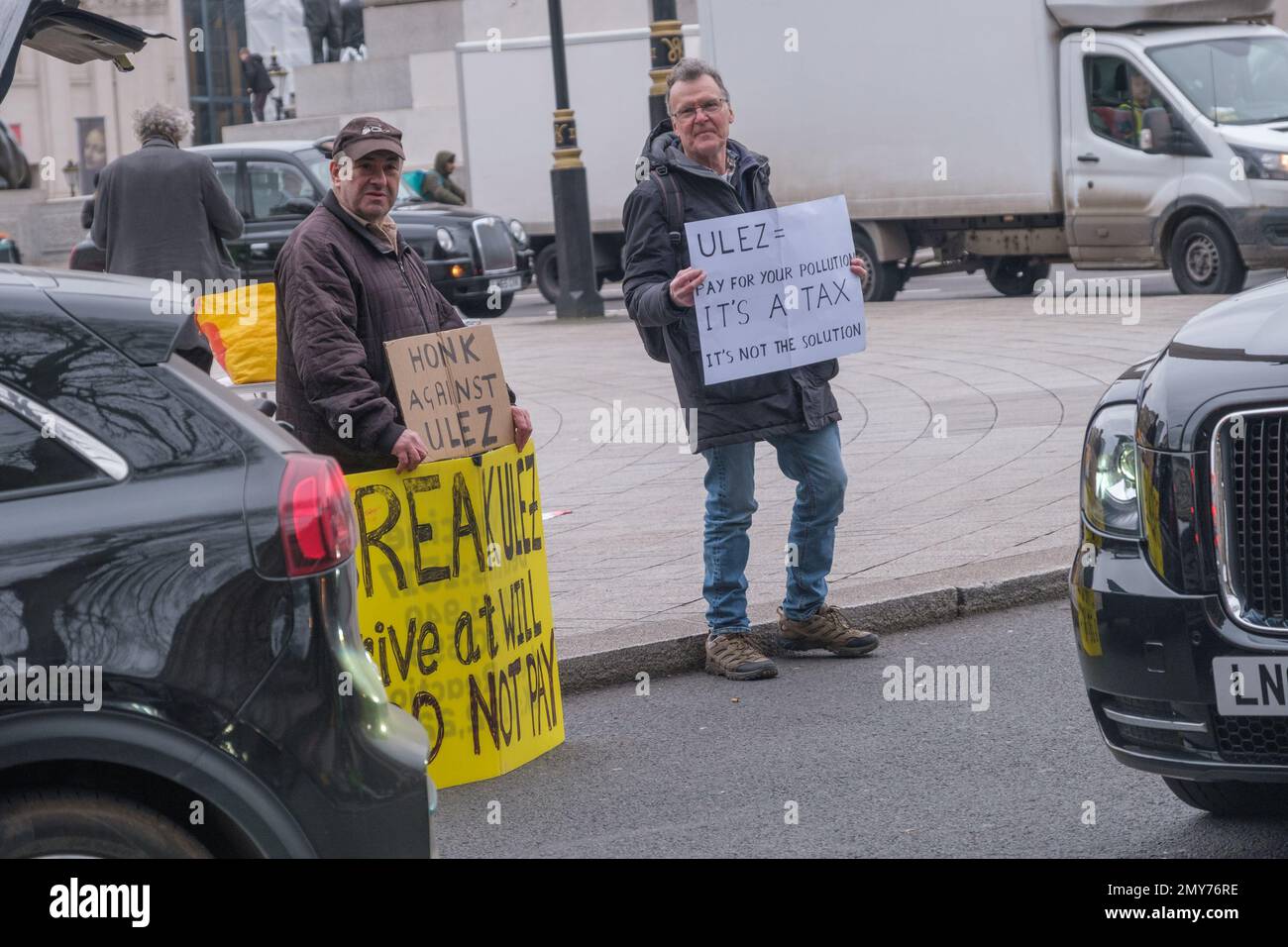 London, UK. Feb 4 2023. A small group stood by the roadside in ...