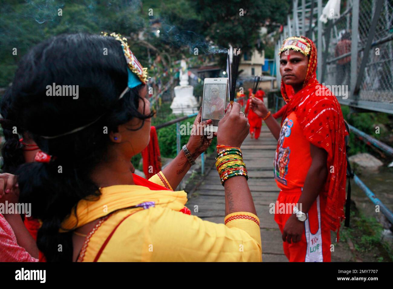 A Hindu devotee takes photos of her friend during Bol Bom pilgrimage ...