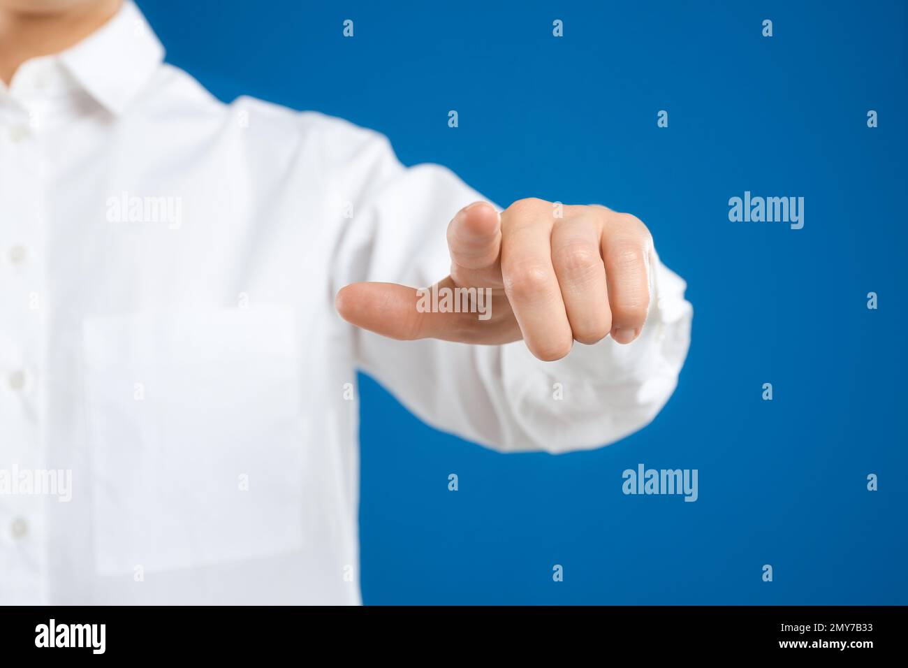 Woman touching something against blue background, focus on hand Stock ...
