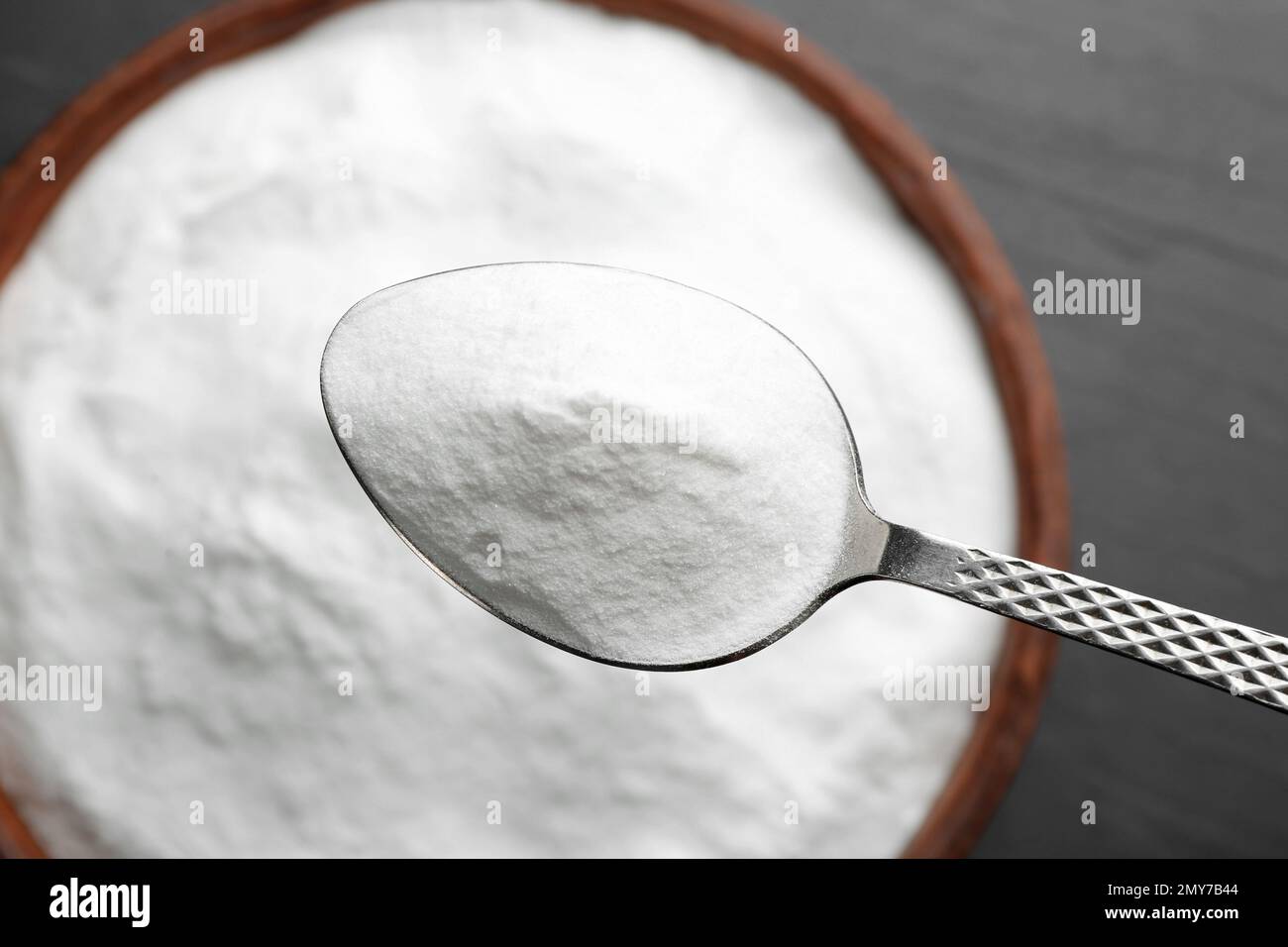Baking soda on black table, top view Stock Photo - Alamy