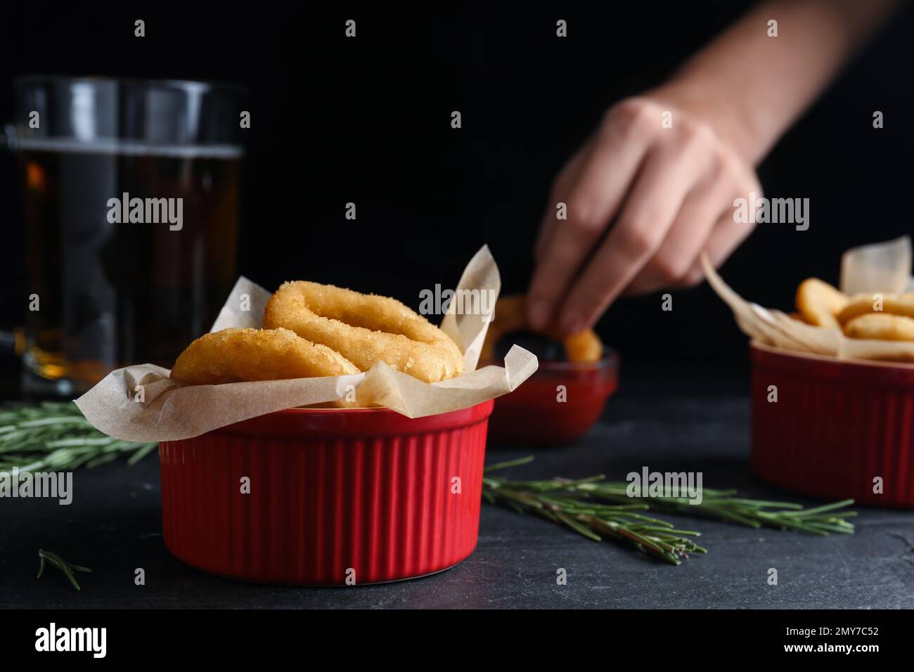 Fried onion rings served on black table in pub Stock Photo - Alamy