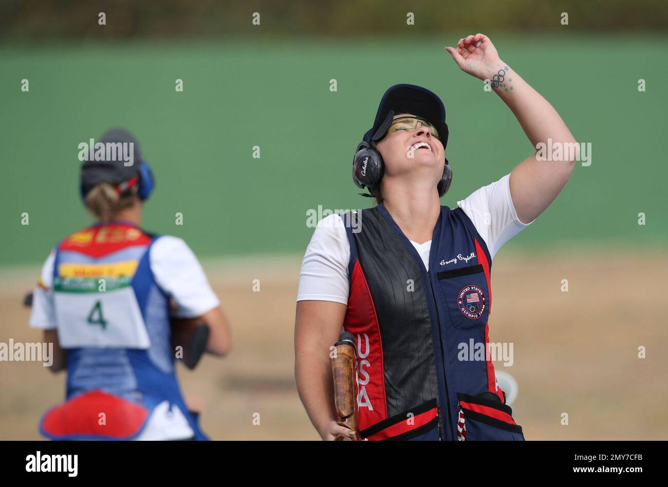 Corey Cogdell, right, of the United States celebrates her victory ...