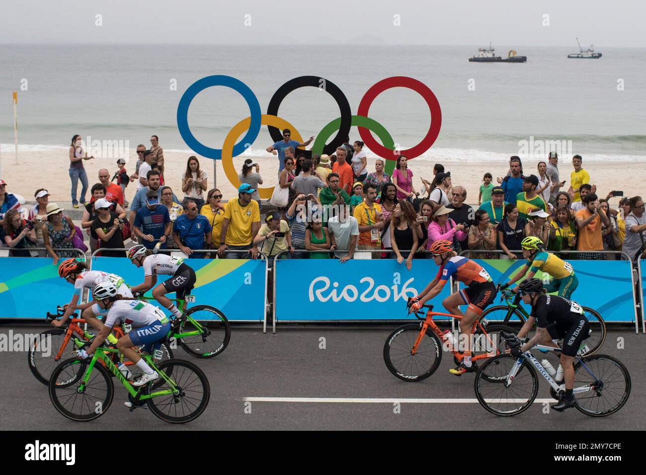 Cyclists ride past the Olympic rings at Copacabana beach after crossing ...