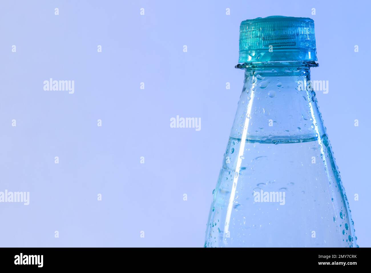 Plastic bottle of pure water on color background, closeup. Space for ...