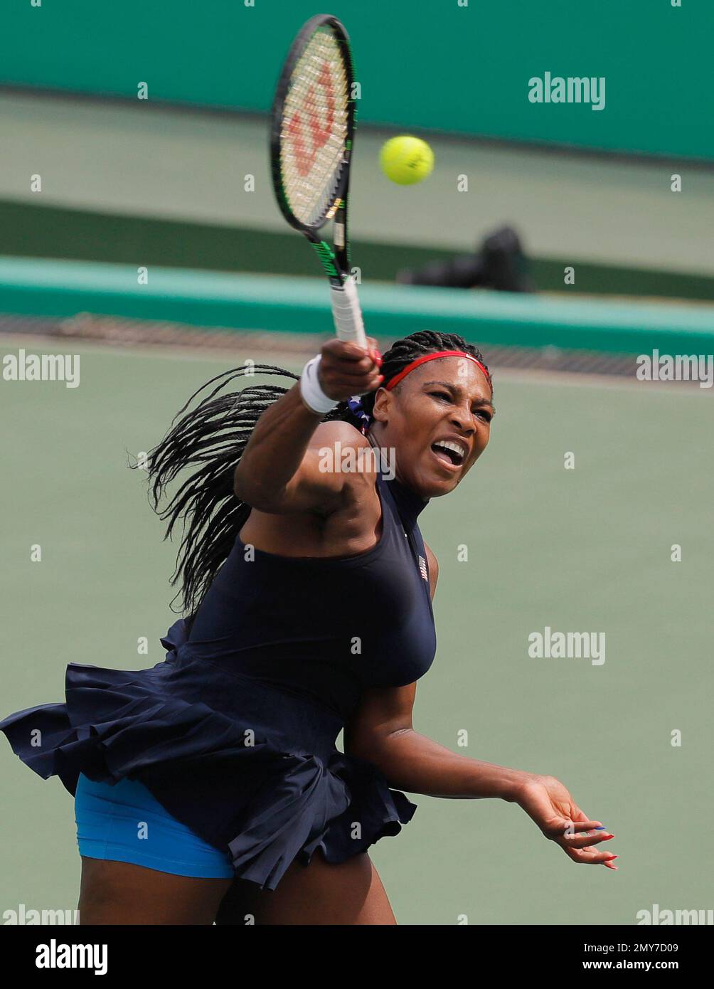 Serena Williams of the United States returns a ball to Australia's ...