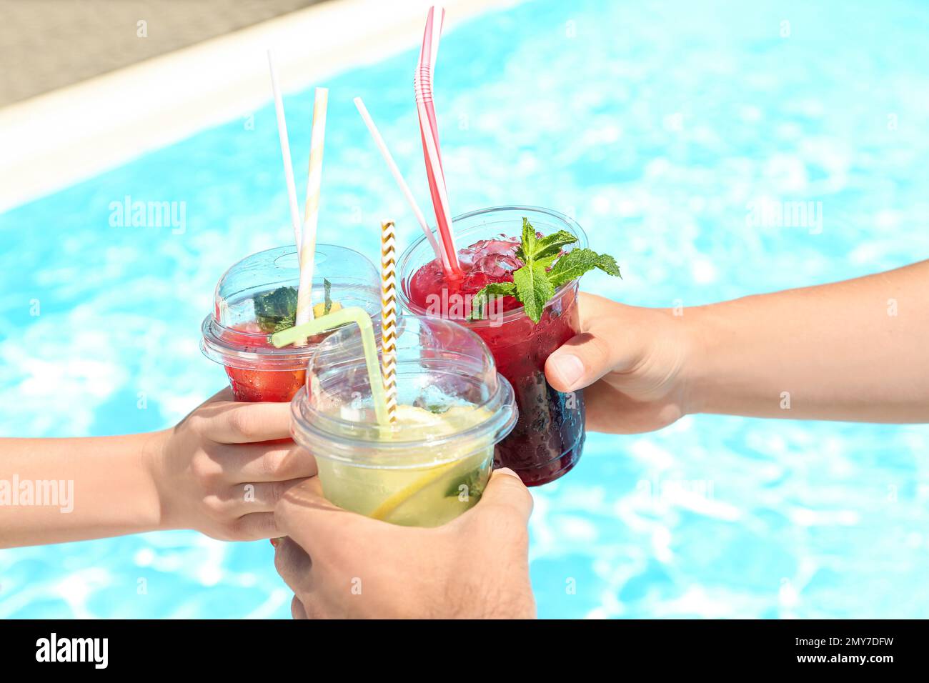 People with refreshing drinks in water park, closeup Stock Photo - Alamy