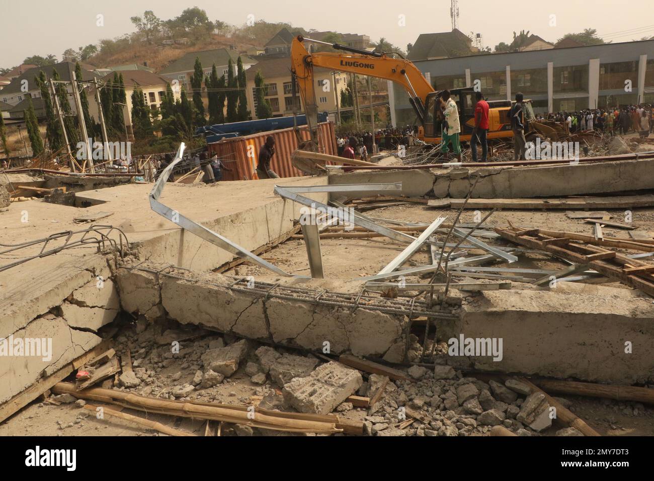 Rescue teams at the site of a 2-story building under construction that collapsed in Abuja ...