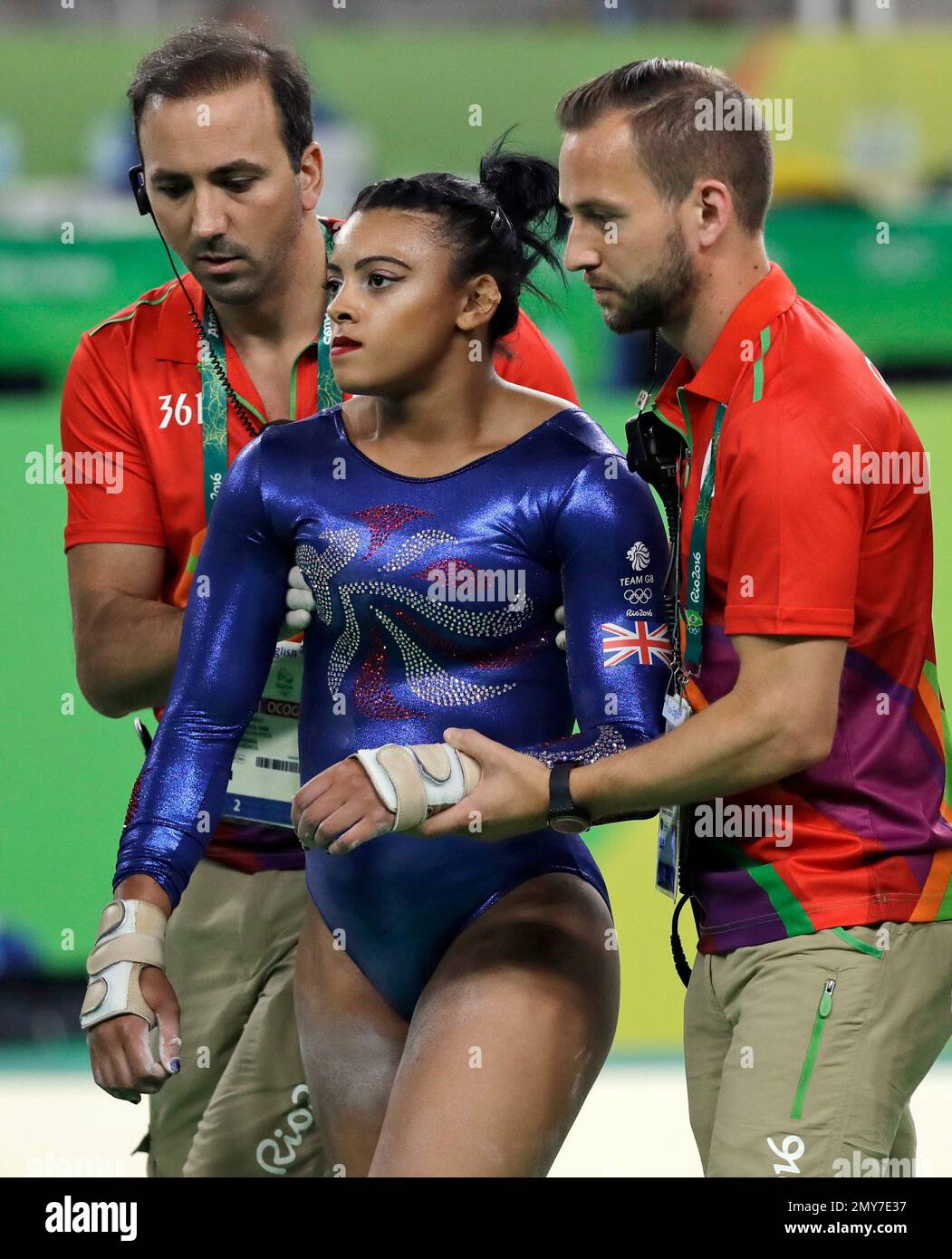 Britain's Elissa Downie is assisted from the floor during the artistic ...