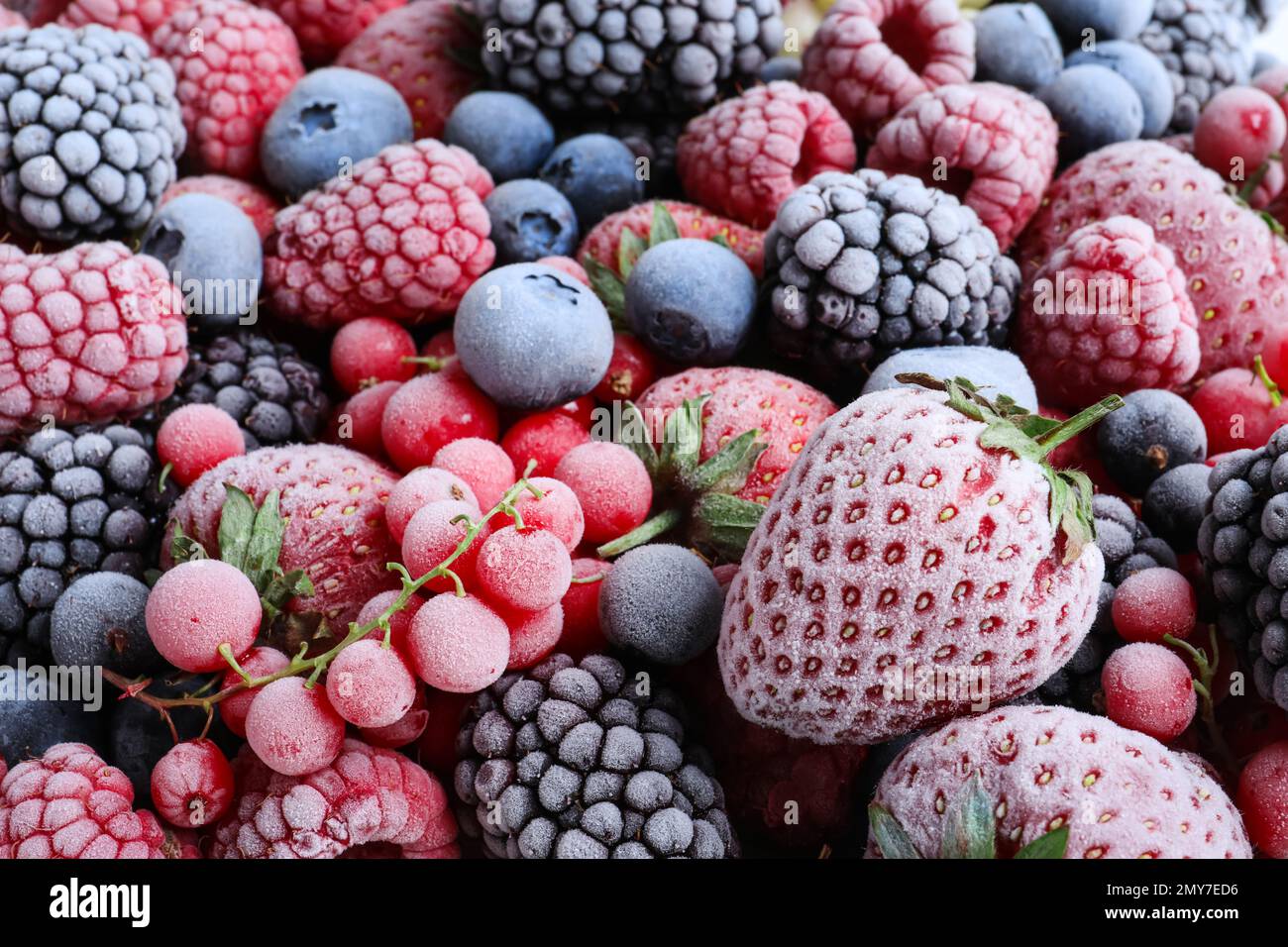 Mix of different frozen tasty berries as background, closeup Stock ...