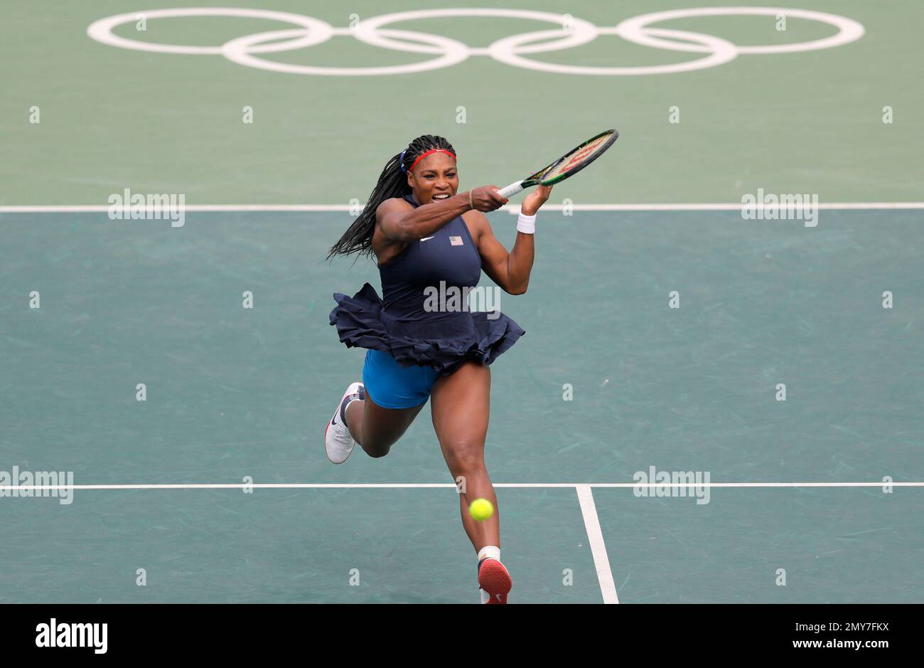 Serena Williams of the United States races to the net during the match ...