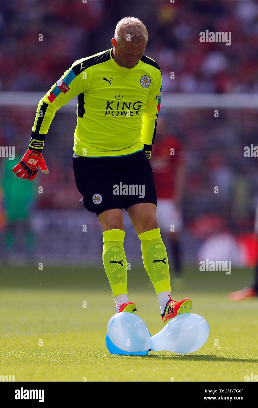 Leicester's goalkeeper Kasper Schmeichel jumps on balloons ahead of the ...