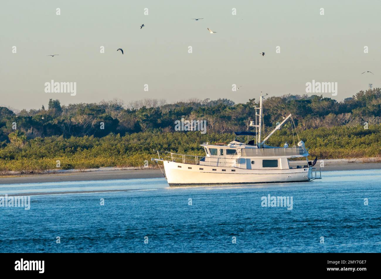 An older model motor yacht boat anchored in the inter-coastal waterway ...
