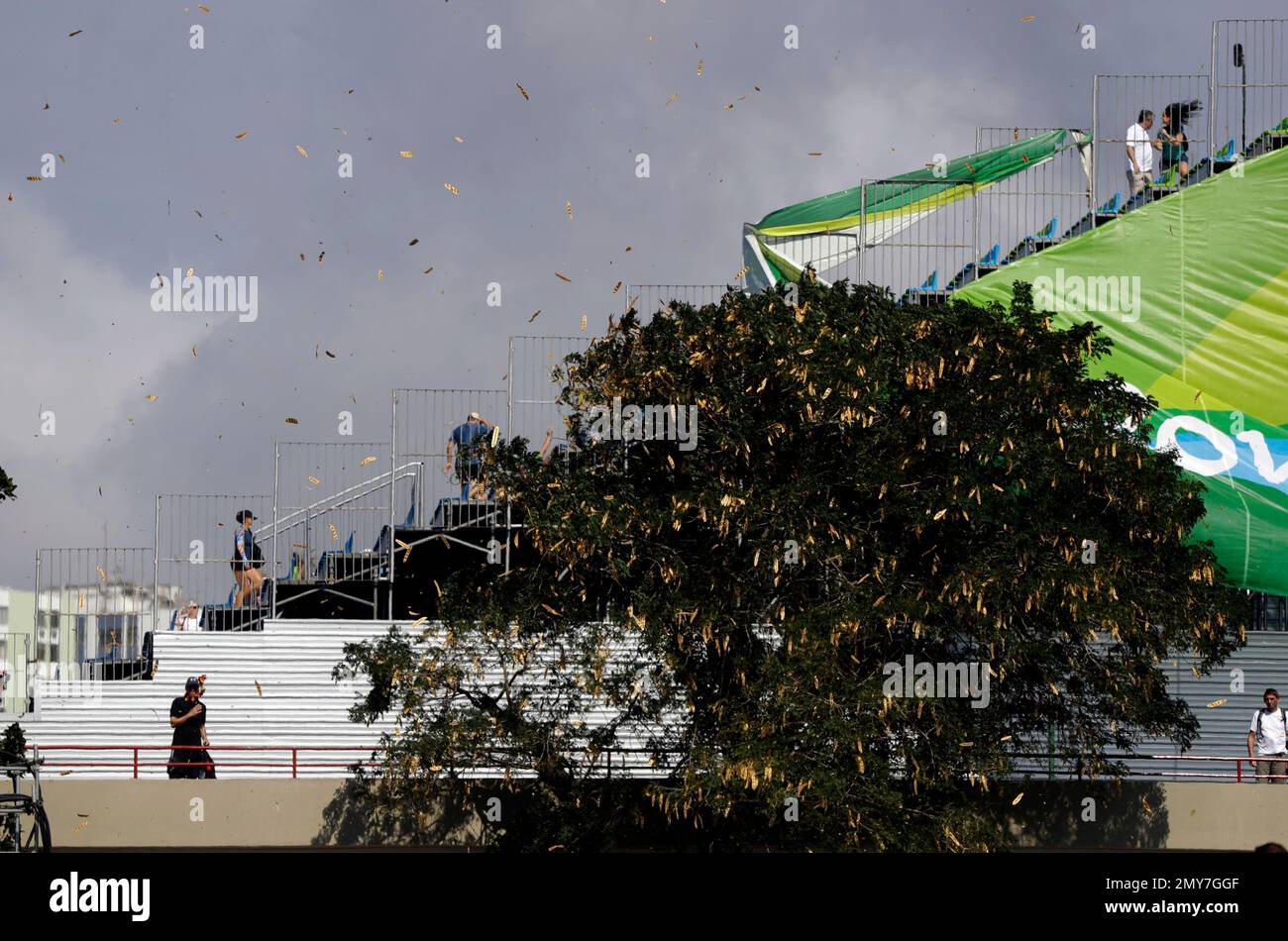 Debris is blown through the grandstands by high winds as spectators ...