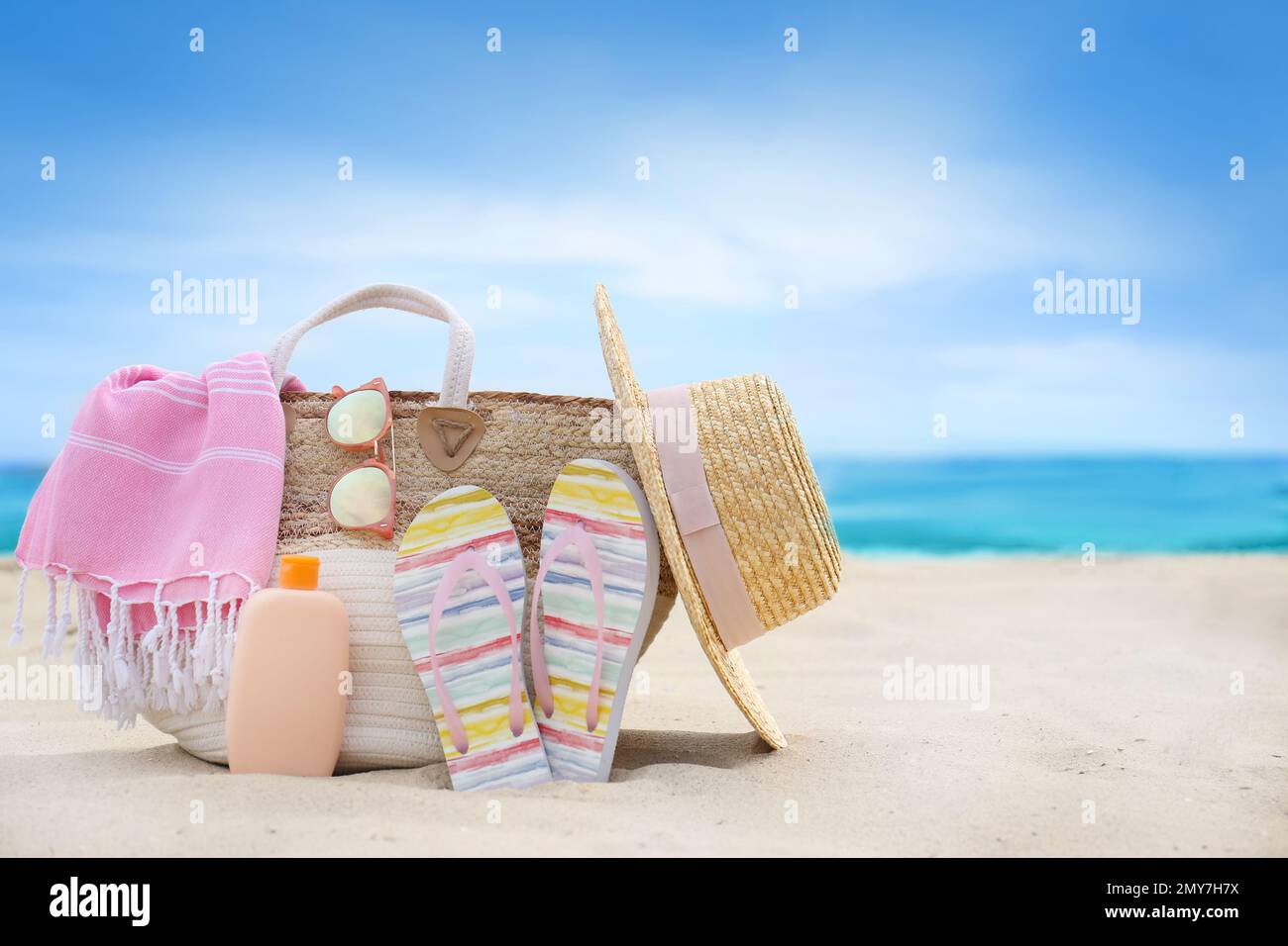 Different stylish beach objects on sand near sea Stock Photo - Alamy