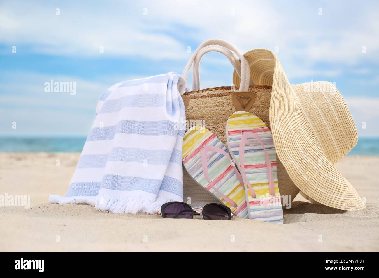 Different stylish beach objects on sand near sea Stock Photo - Alamy