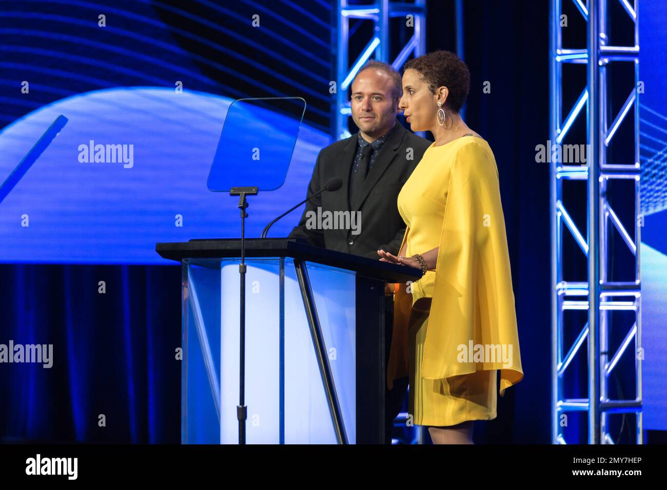 Jarett Wieselman, left, and Melanie McFarland present the award for ...