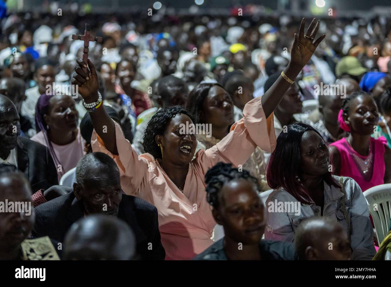 People sing as Pope Francis conducts an ecumenical prayer at the John ...