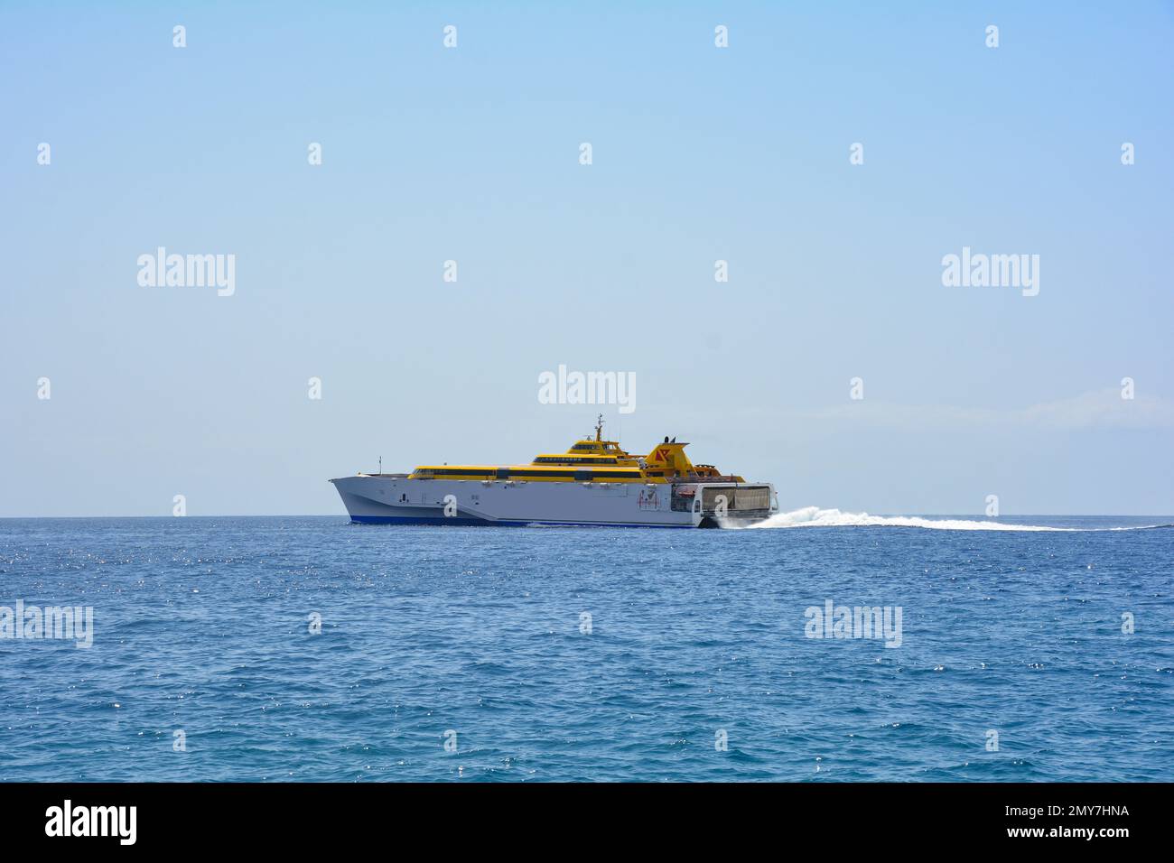 A passenger ferry boat sails across the open blue sea Stock Photo - Alamy