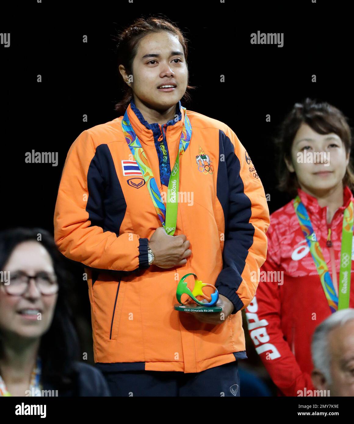 Sopita Tanasan, of Thailand, center, listens to her country's national ...