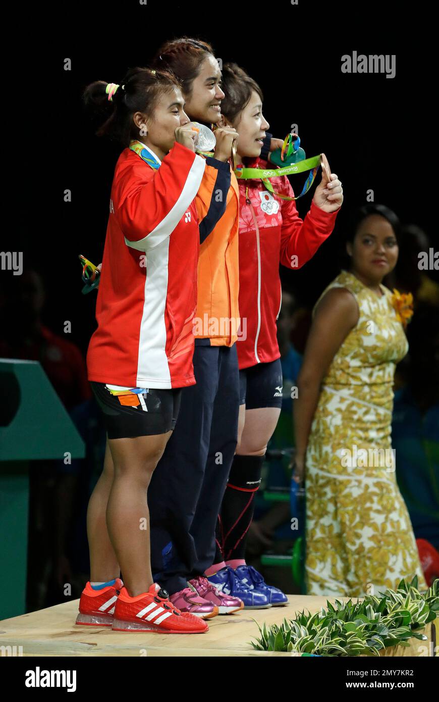 Sopita Tanasan, of Thailand, center, holds her gold medal as she poses ...